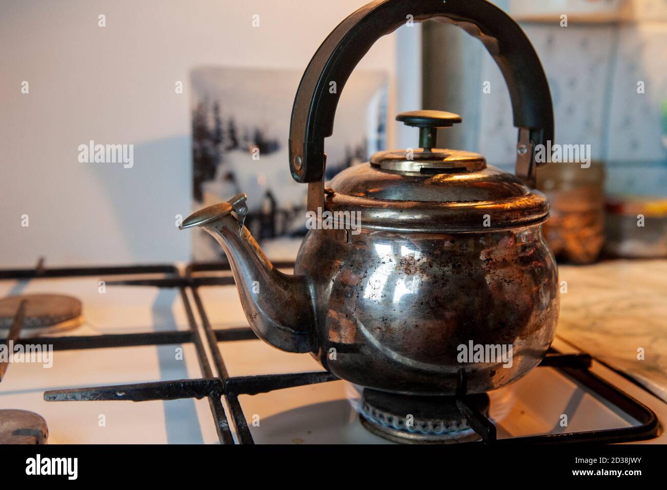 Polished old tea kettle pot sitting on a gas stove Stock Photo - Alamy