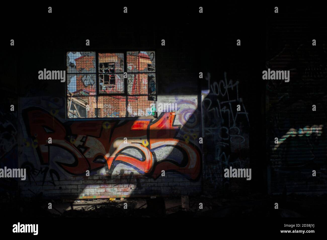 A ruined building visible through the broken windows of the abandoned ...