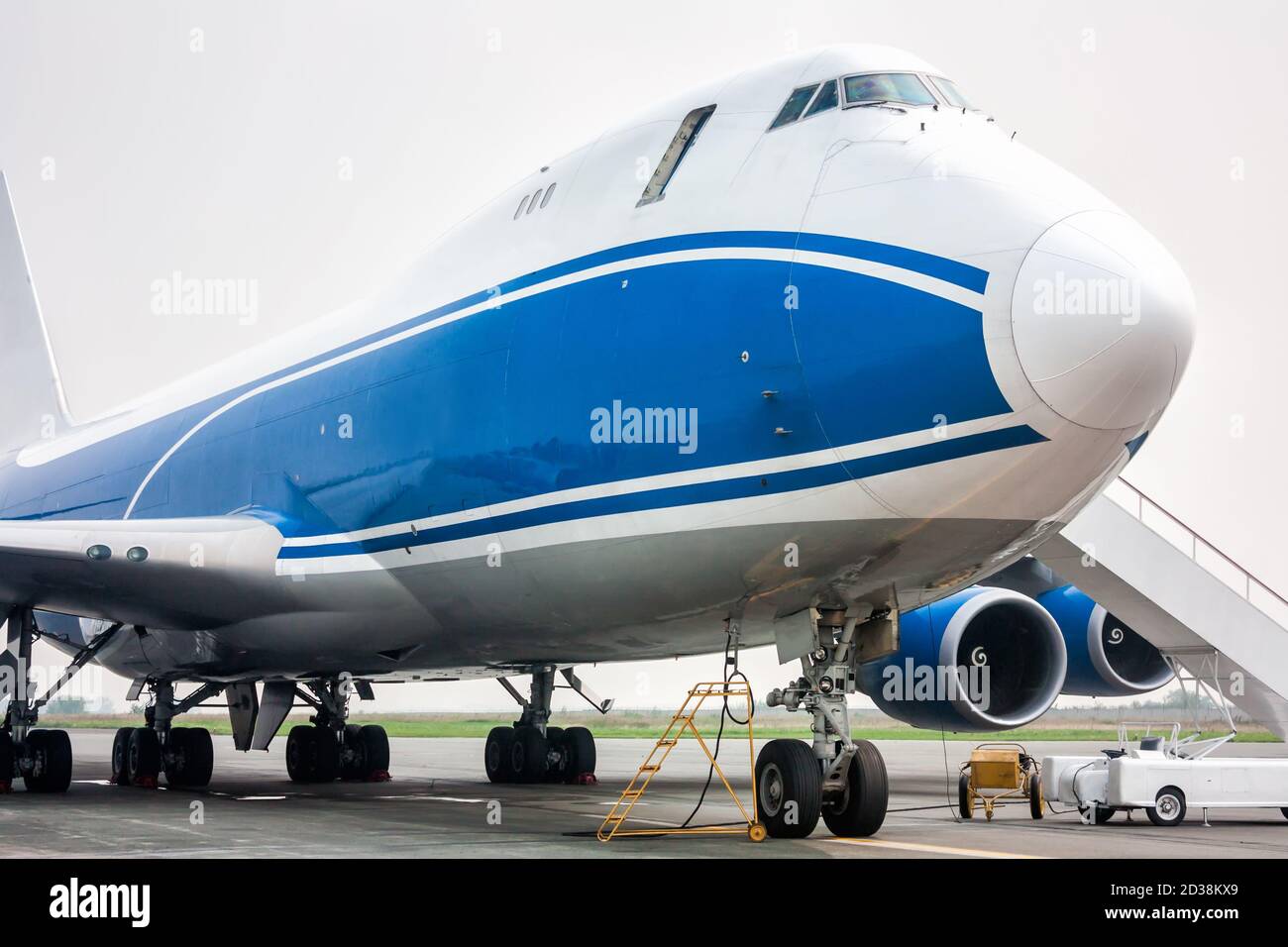 Close-up of big cargo wide body aircraft with opened door and boarding ...