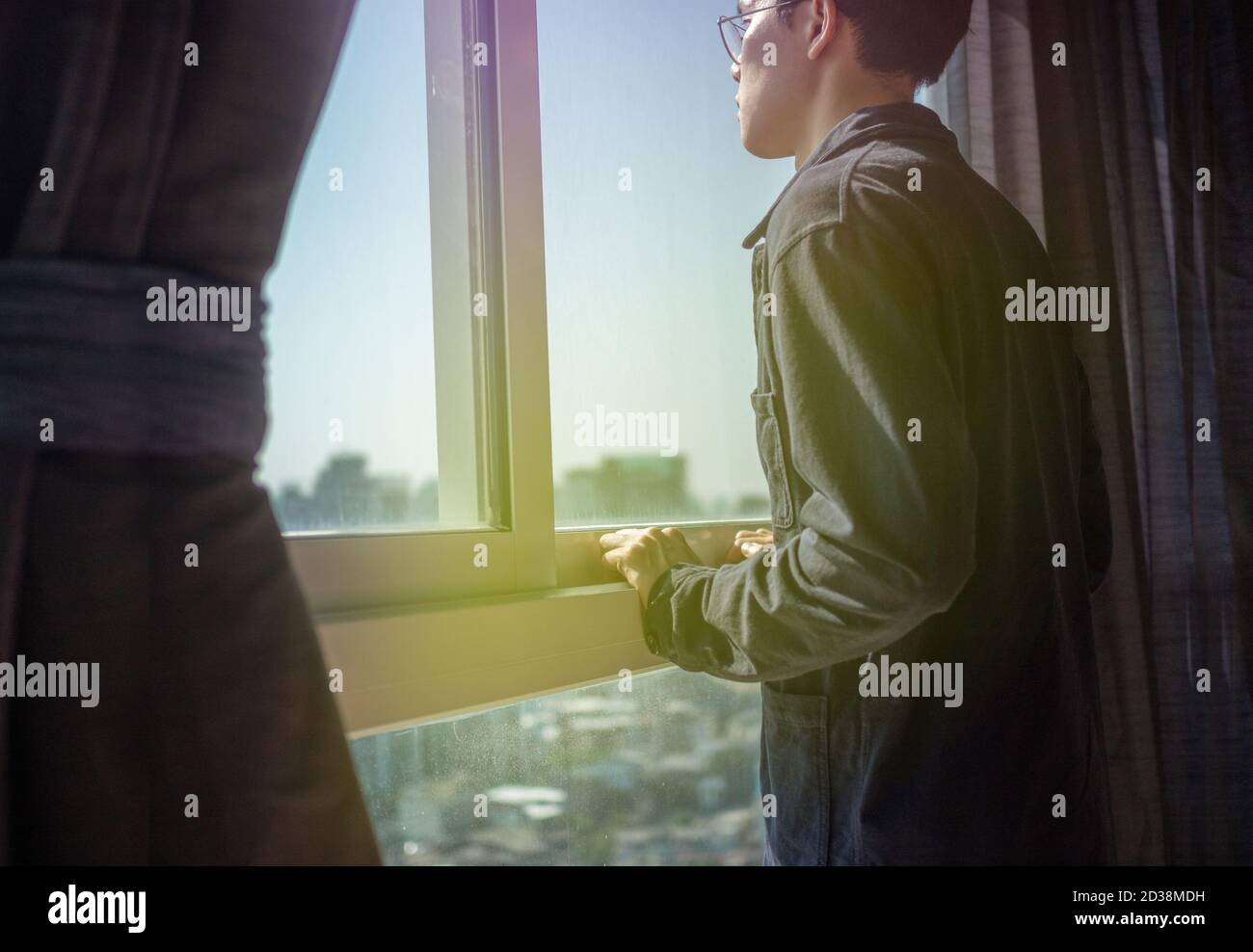 Man putting hands on windows, alone look out the room Stock Photo - Alamy