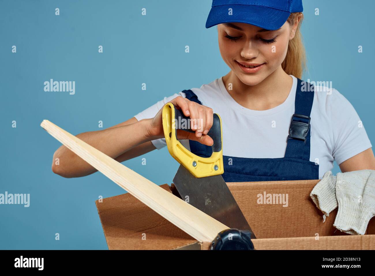 Working woman in uniform with box in hands tools loading delivery ...