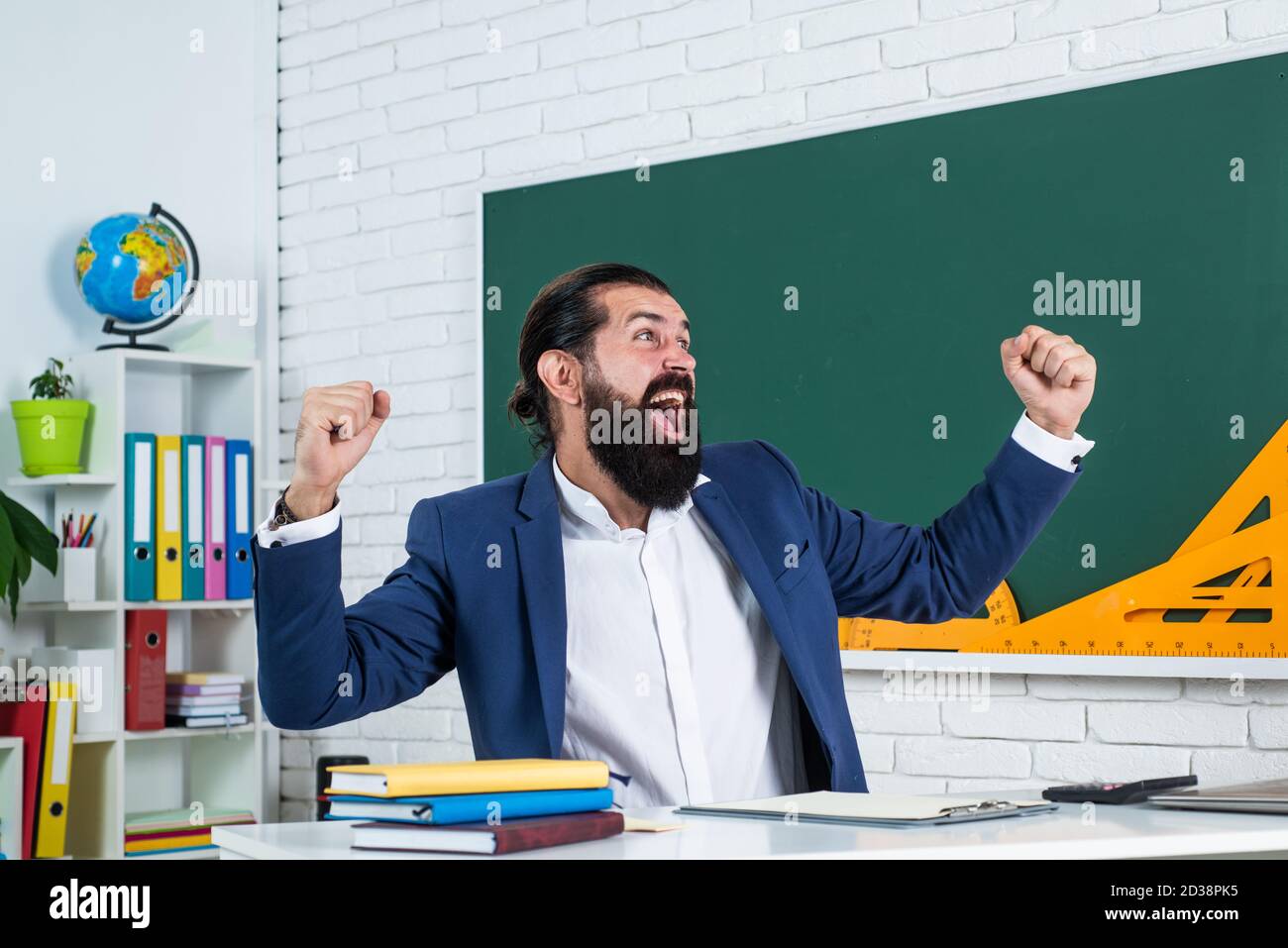 happy man with beard celebrate successfully passed exam in school or ...