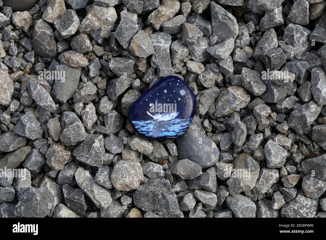 High angle shot of a beautifully painted stone on the small rocks Stock ...