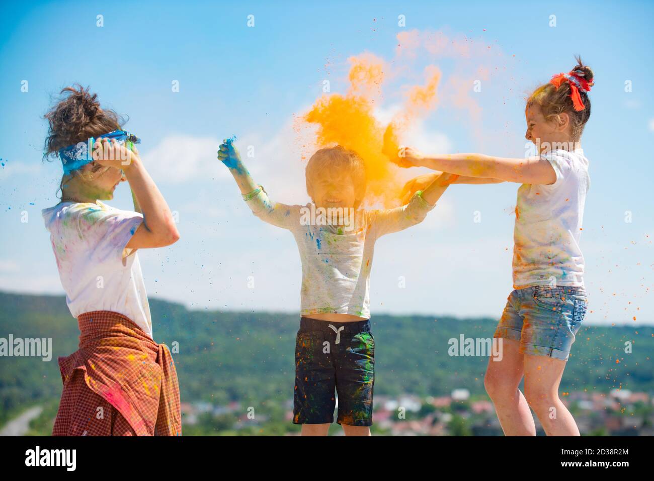 Kids playing with holi color powder. Children celebrating holi festival ...