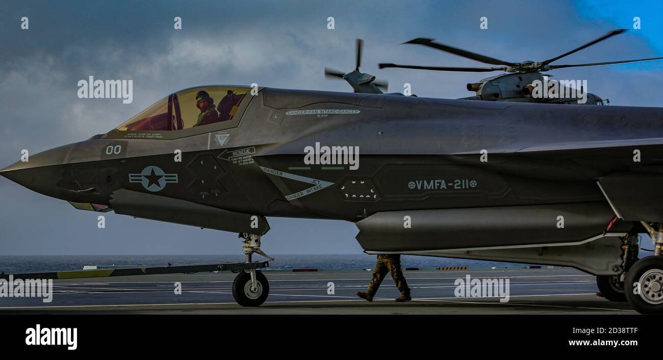 A Marine with Marine Fighter Attack Squadron (VMFA) 211 taxis an F-35B ...