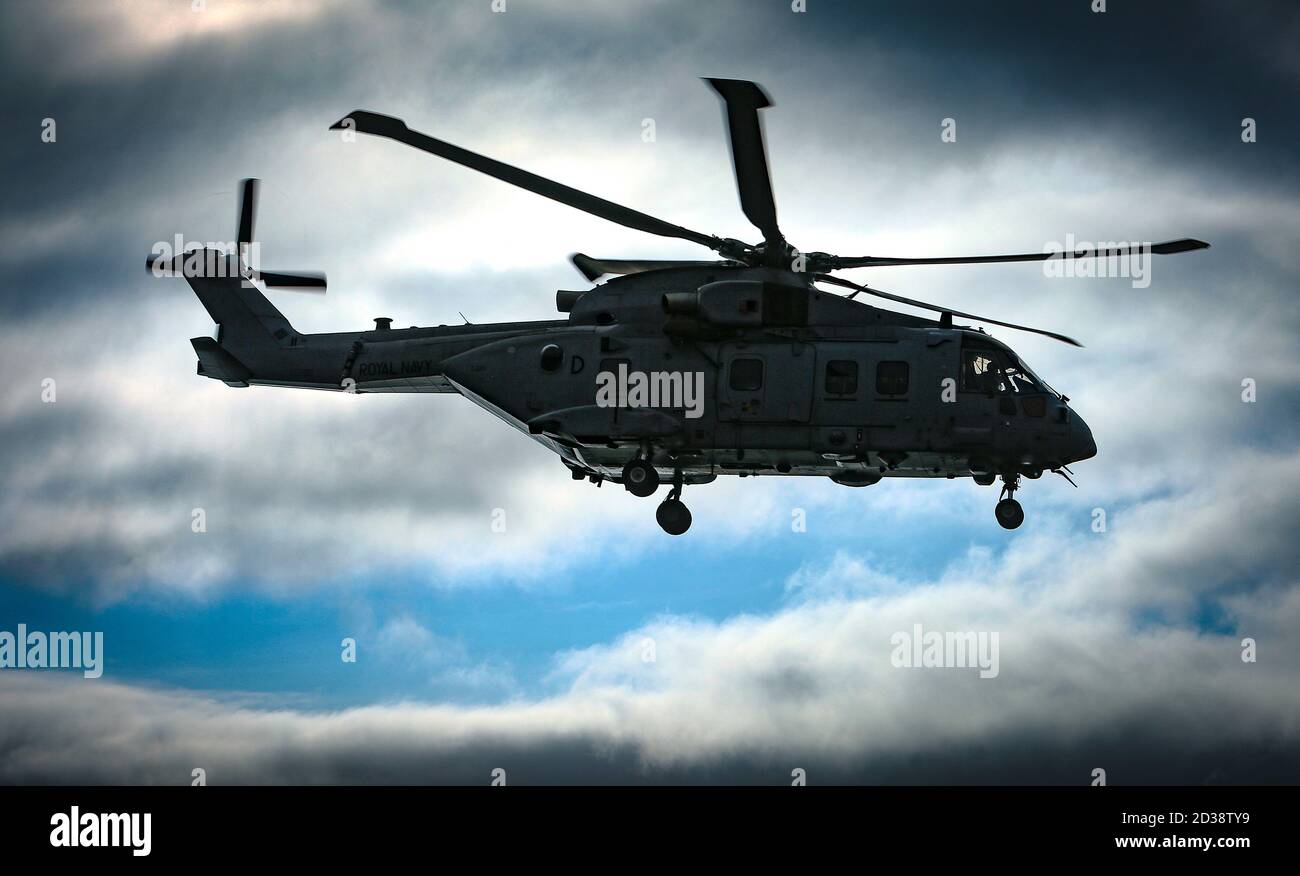 A Royal Navy Merlin Helicopter flies above Her Majesty's Ship (HMS ...