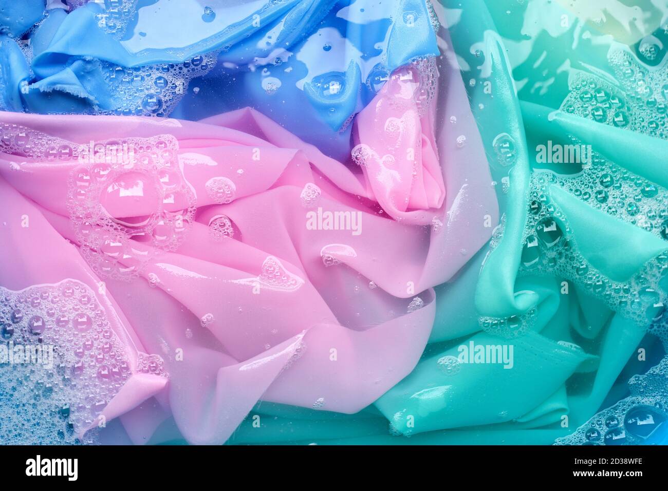 Color clothes soak in powder detergent water dissolution. Laundry ...