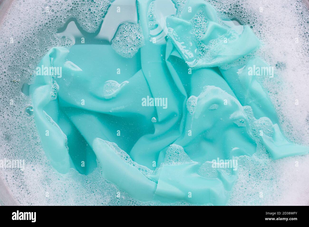 Color clothes soak in powder detergent water dissolution. Laundry ...