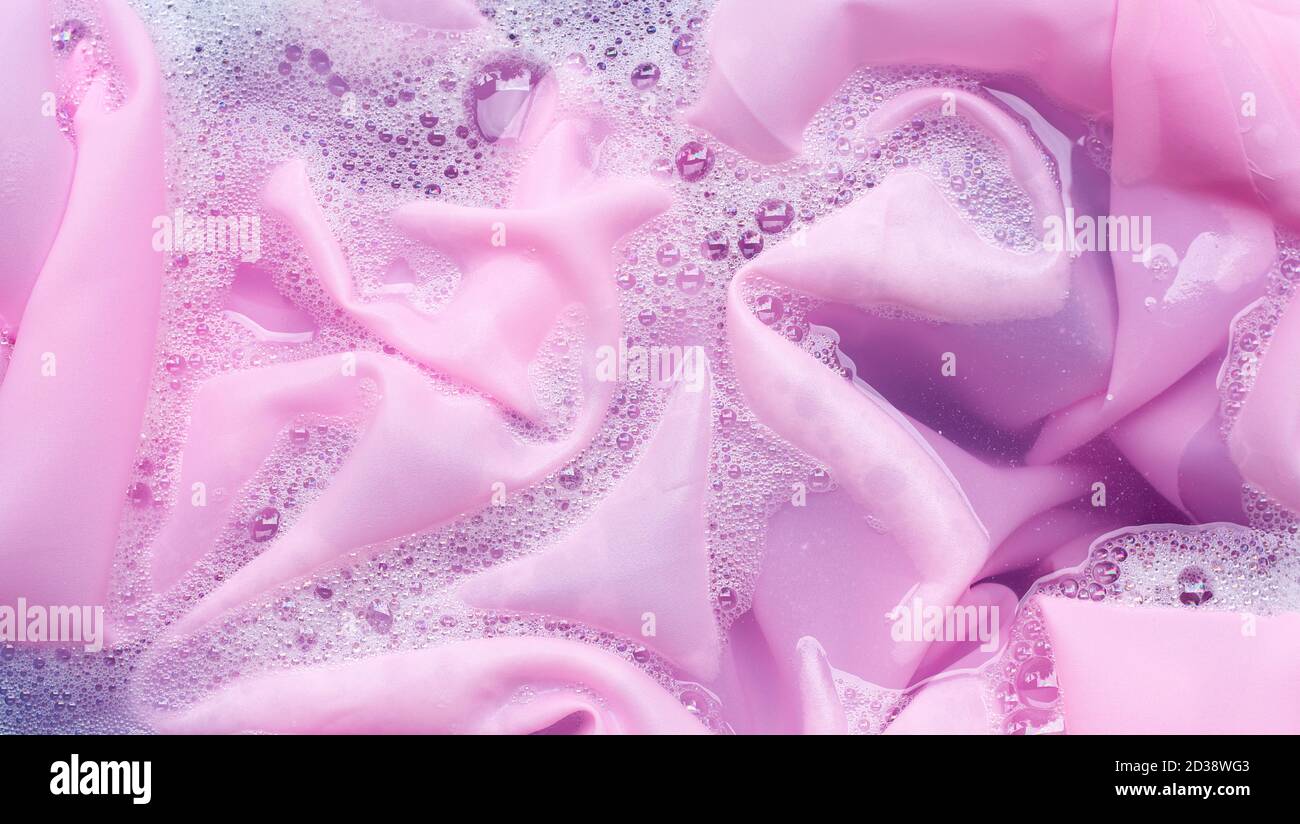 Color clothes soak in powder detergent water dissolution. Laundry ...