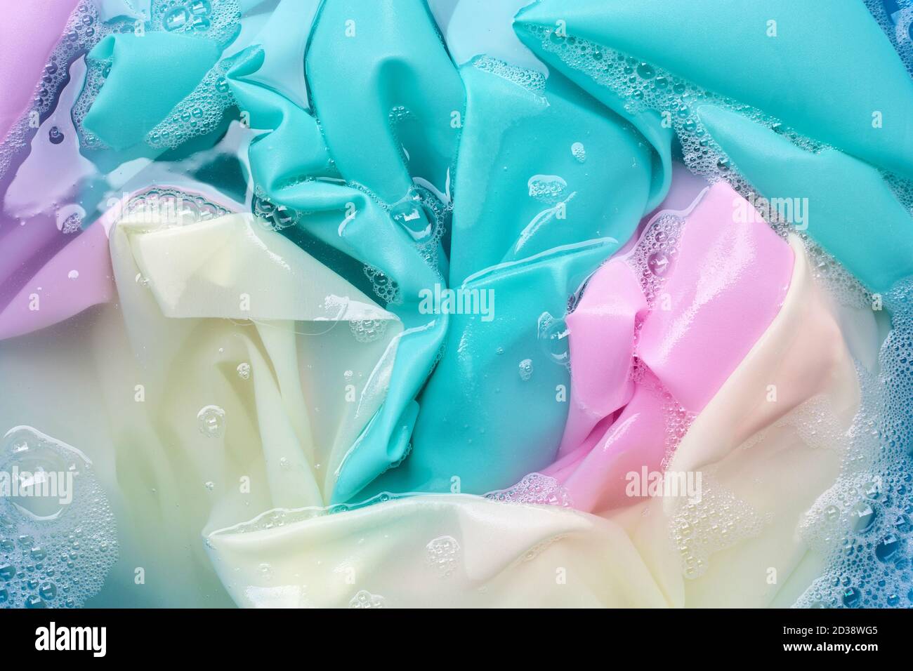 Color clothes soak in powder detergent water dissolution. Laundry ...