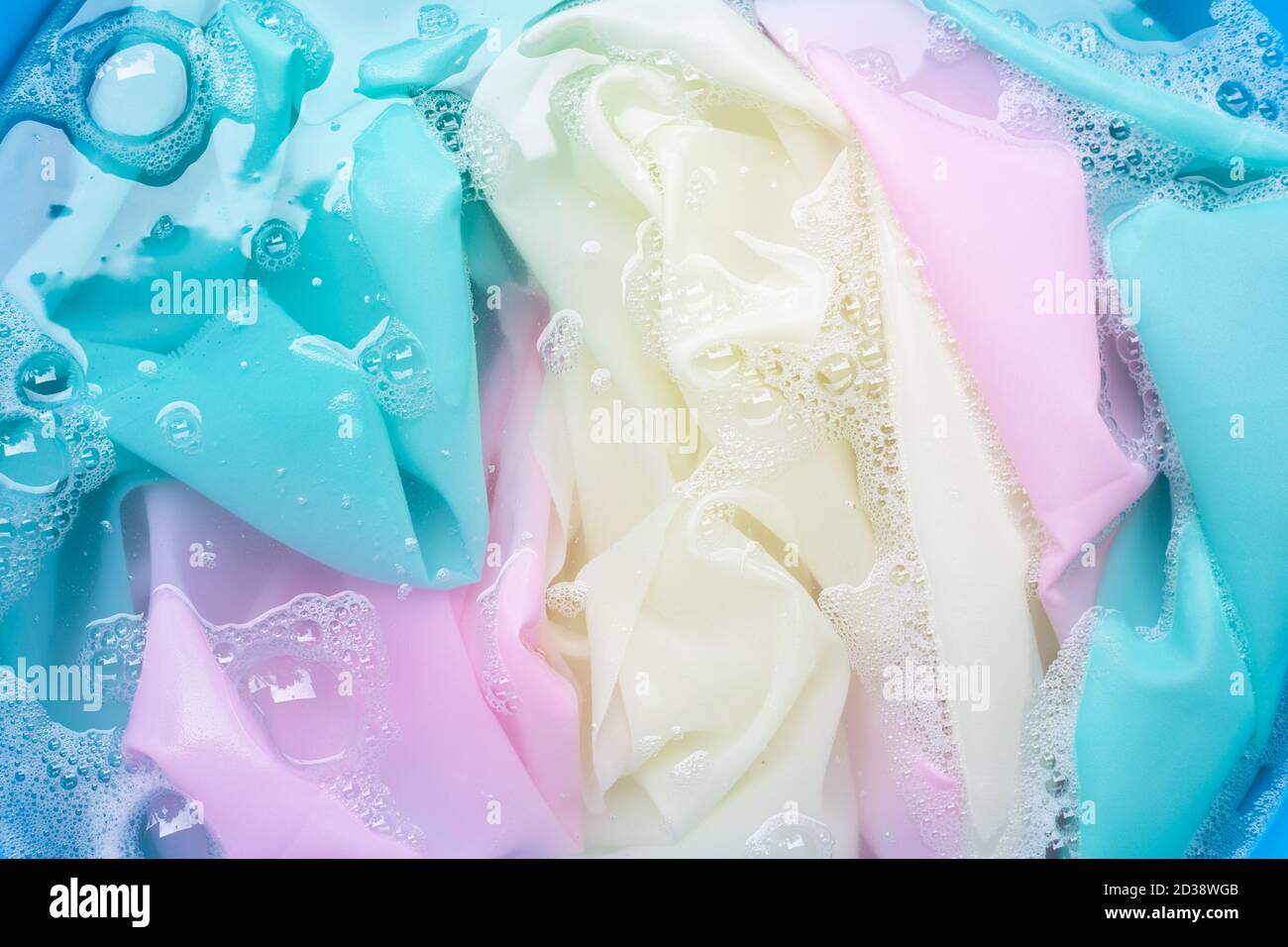 Color clothes soak in powder detergent water dissolution. Laundry ...