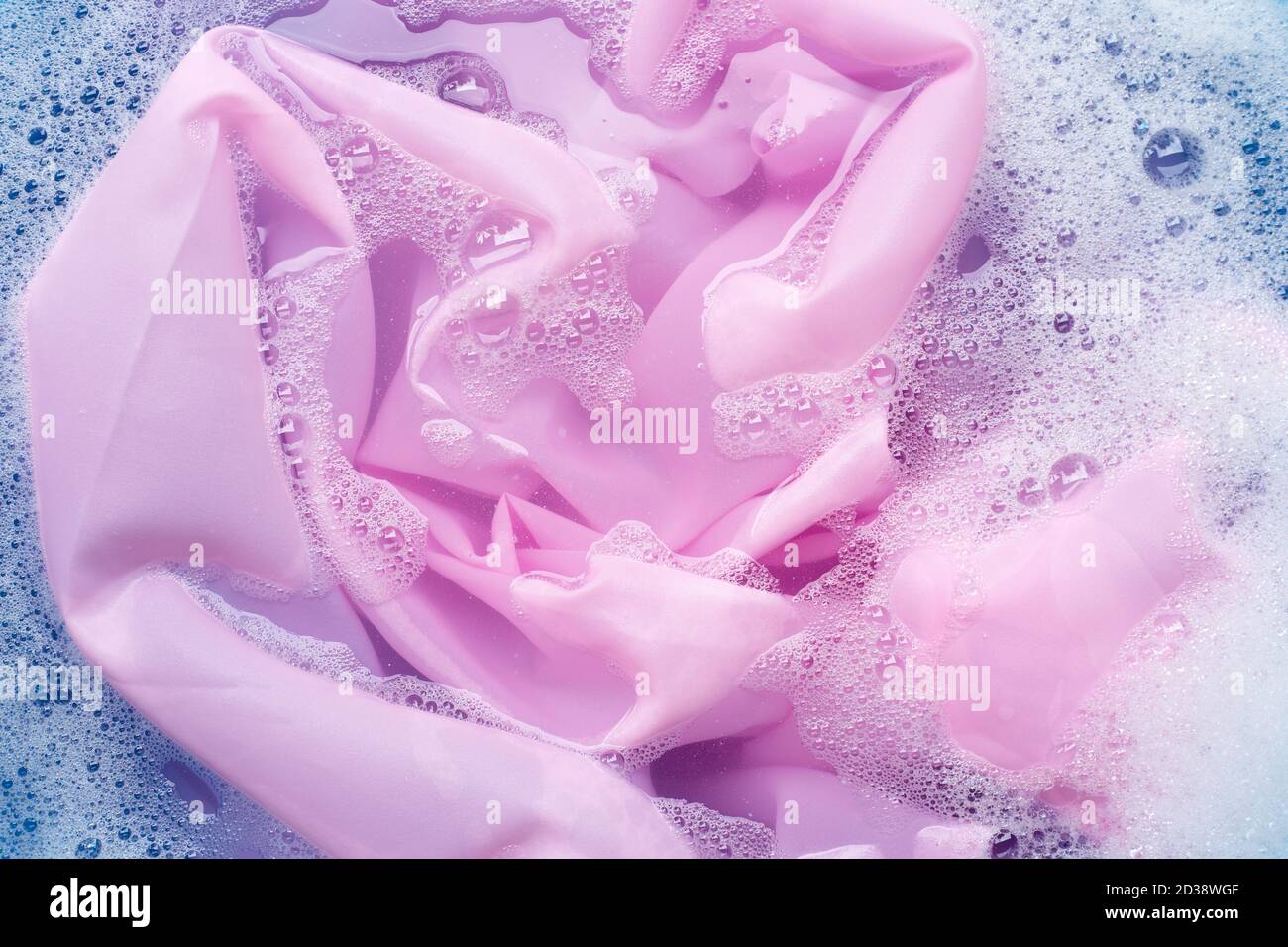 Color clothes soak in powder detergent water dissolution. Laundry ...