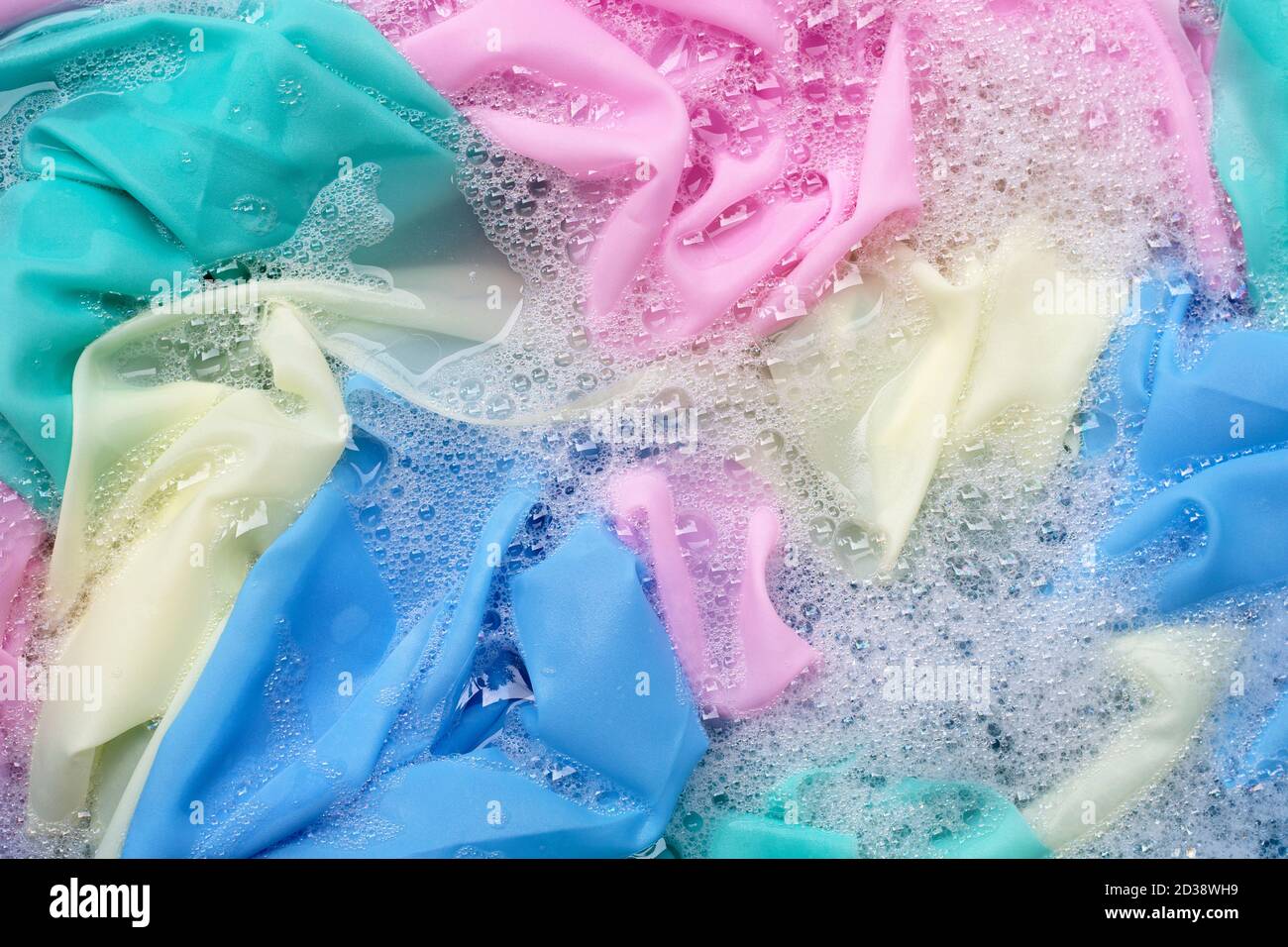 Color clothes soak in powder detergent water dissolution. Laundry ...