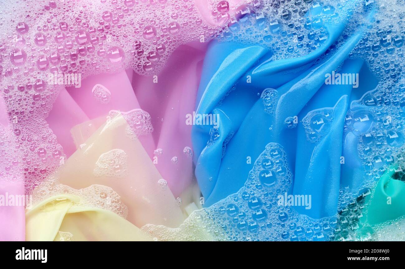 Color clothes soak in powder detergent water dissolution. Laundry ...
