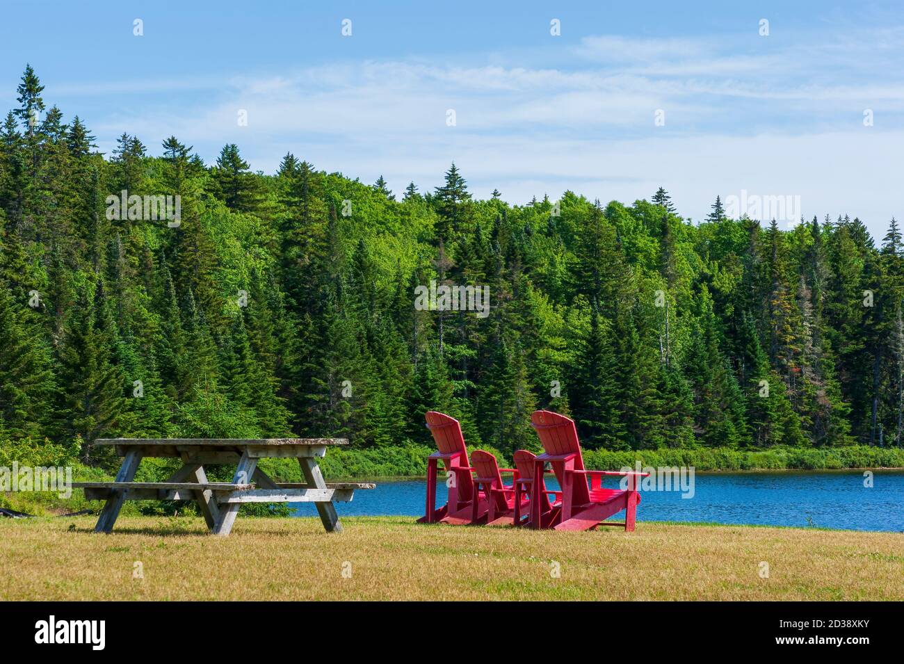 Picnic table and assortment of four red Adirondack chairs at a lookout ...
