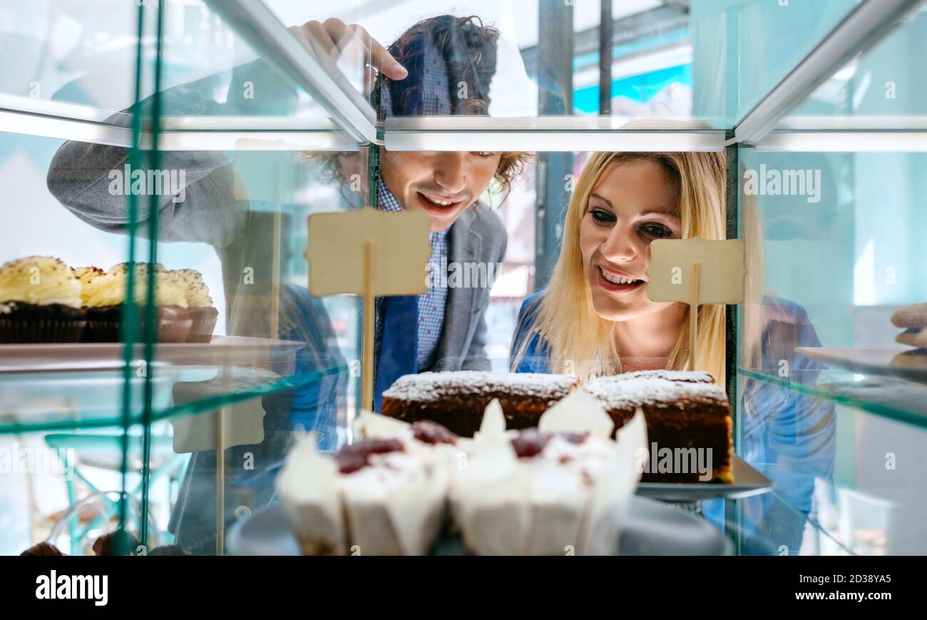 Couple choosing a cake Stock Photo - Alamy