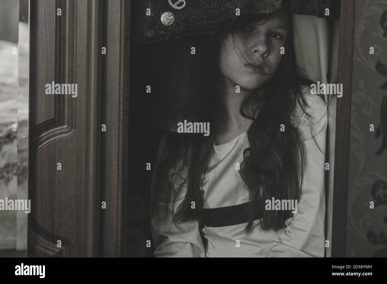 Child scared of nightmare and hiding in closet. Ghost of little girl ...