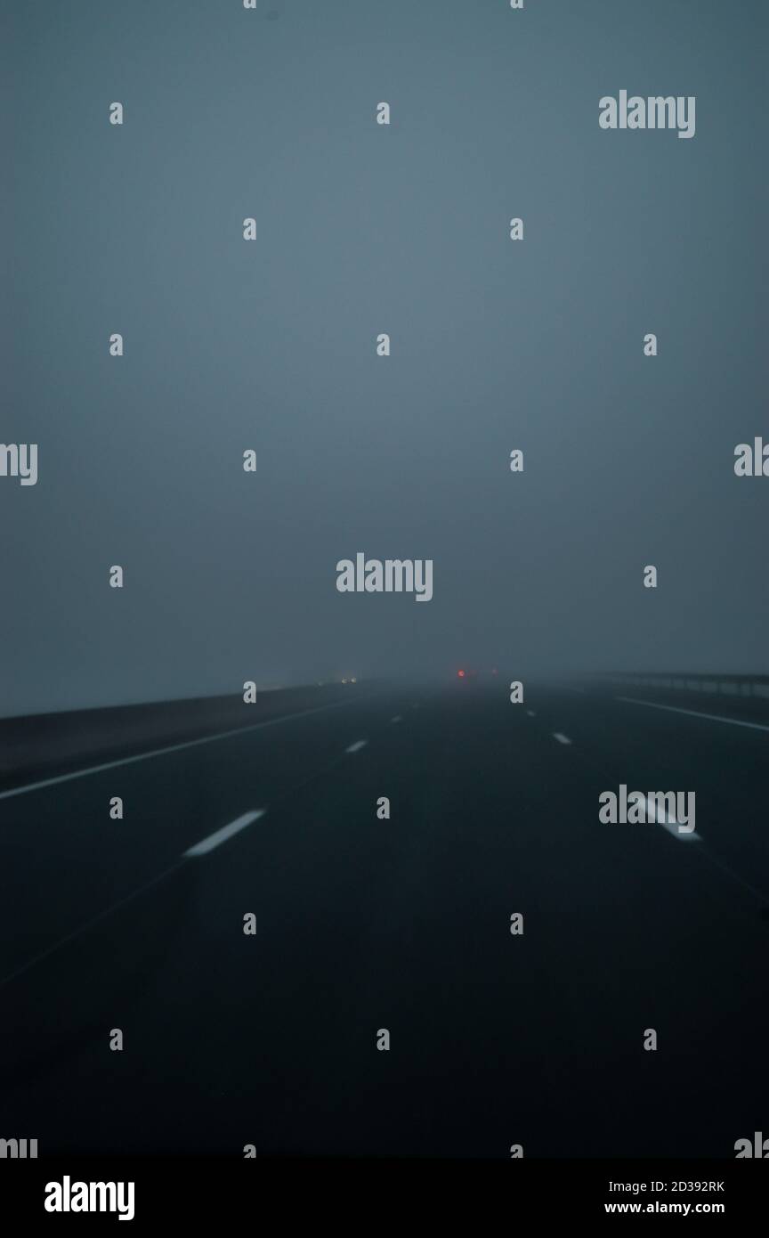 really foggy motorway with very poor visibility Stock Photo - Alamy