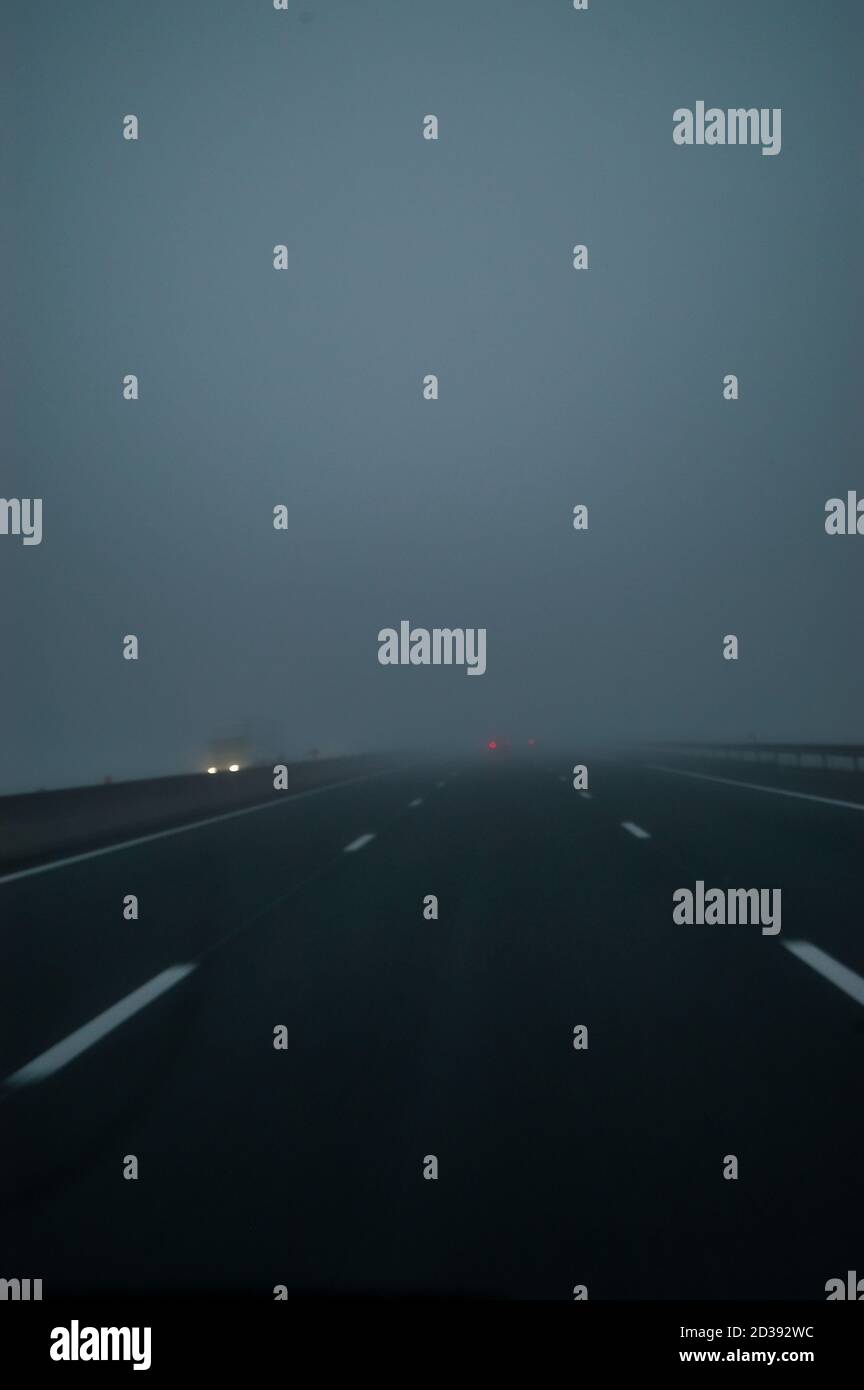 drivers view of fog on a dark motorway Stock Photo - Alamy