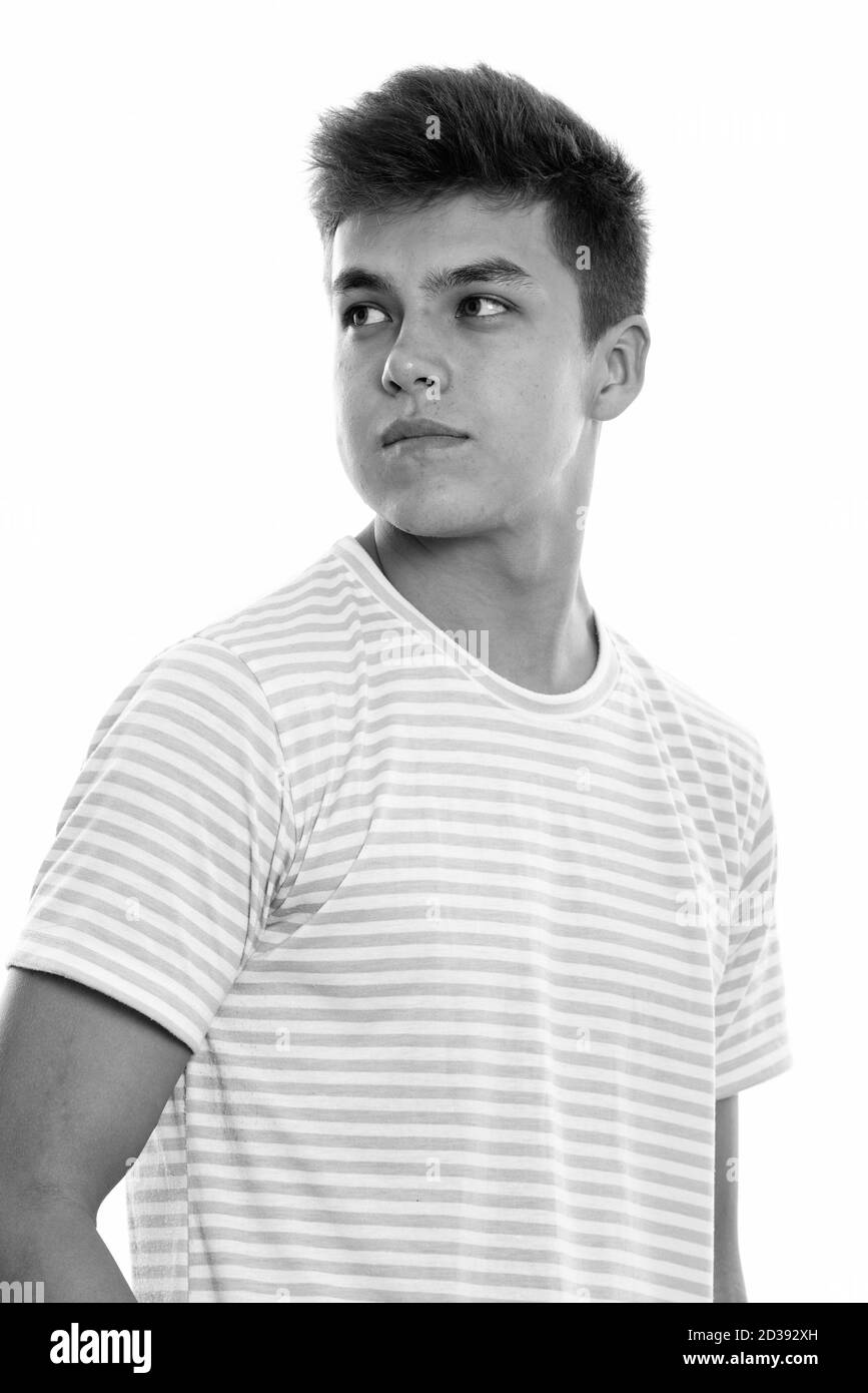 Studio shot of thoughtful young handsome man looking back Stock Photo ...