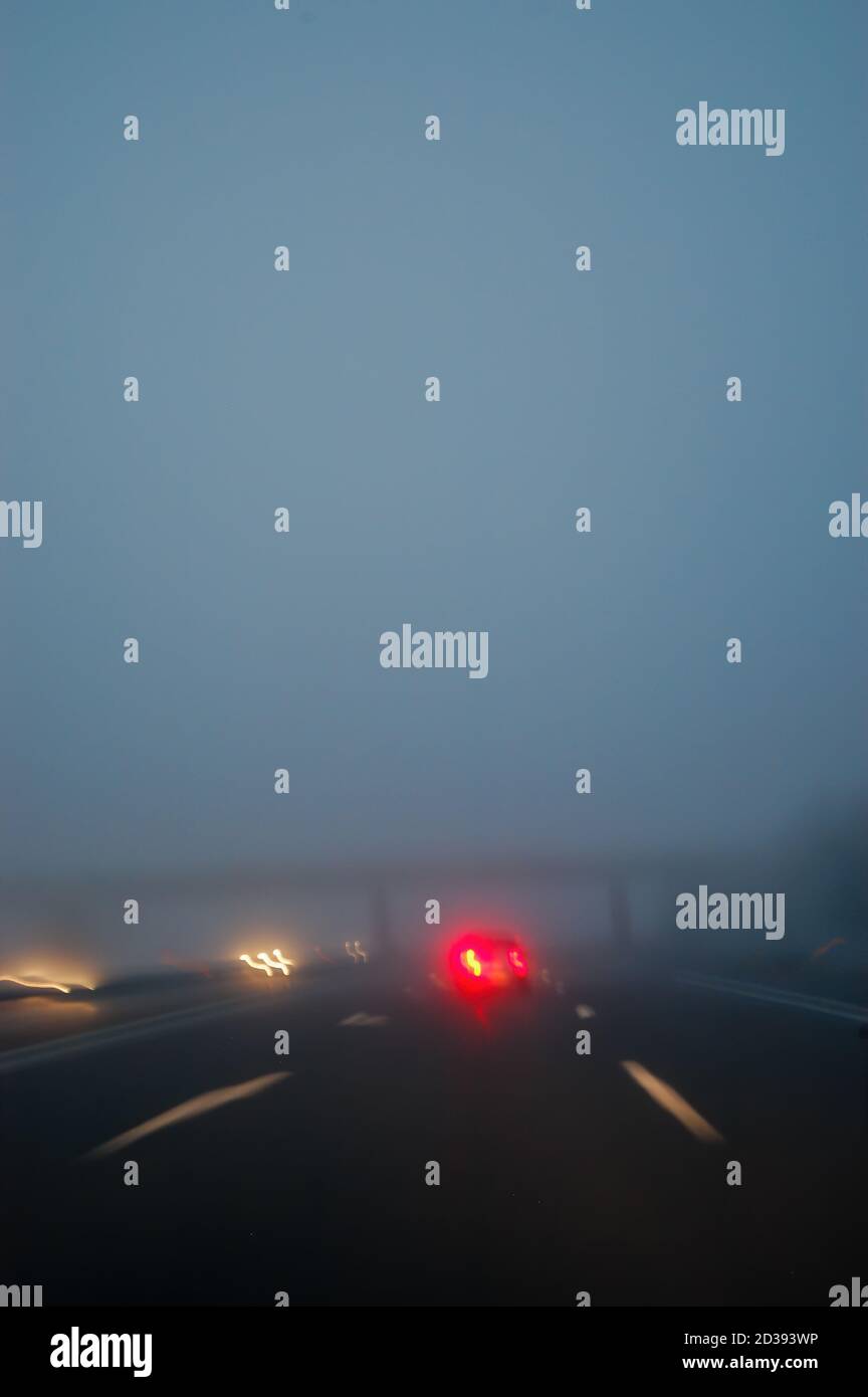 drivers view of fog on a dark motorway Stock Photo - Alamy
