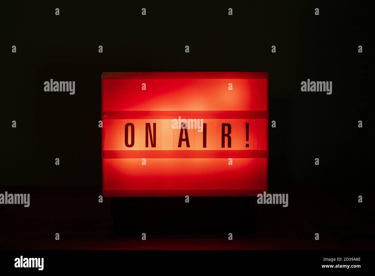 a bright red colored sign with the word ON AIR Stock Photo - Alamy