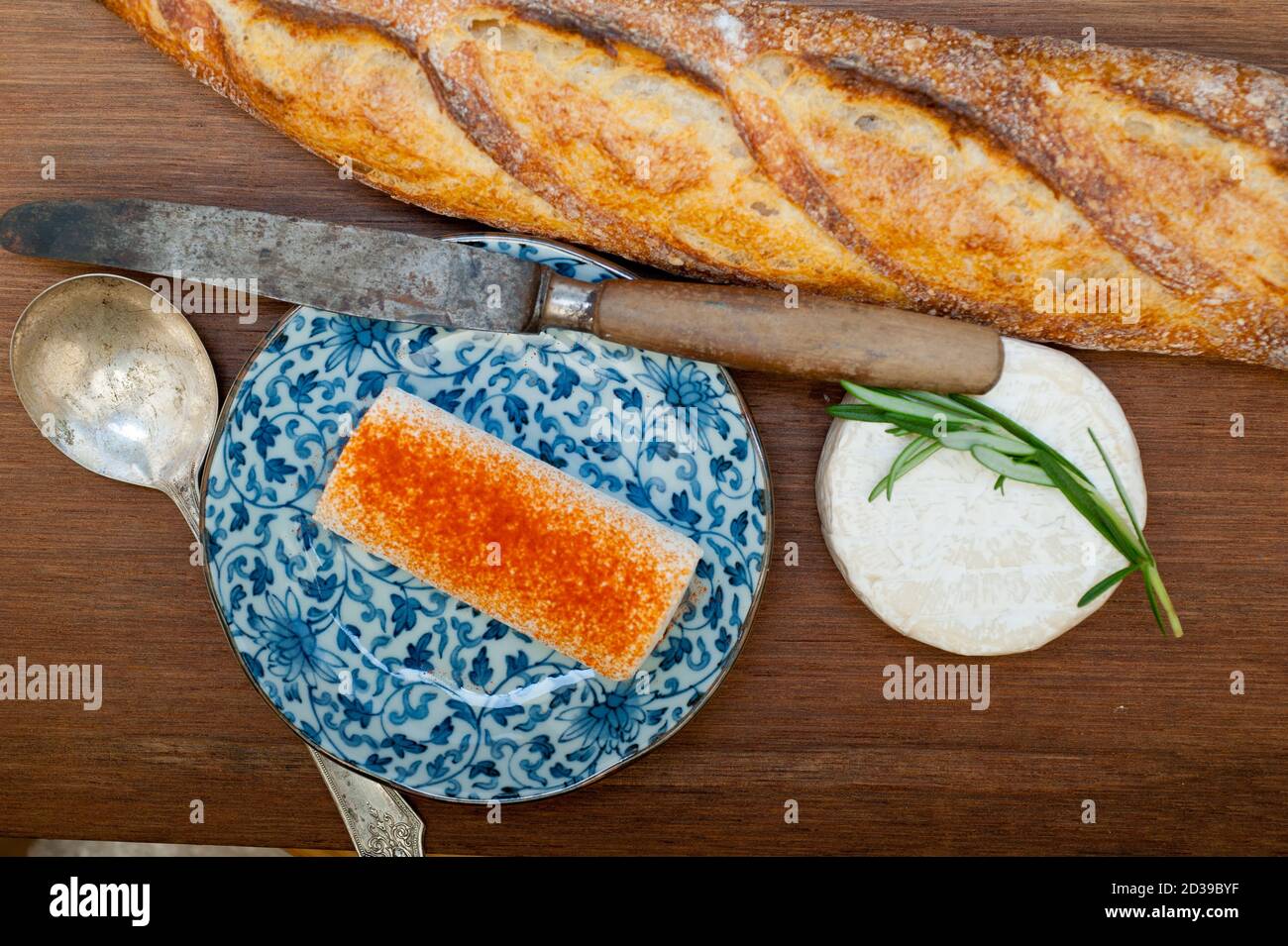 French cheese and fresh baguette on a wood cutter Stock Photo - Alamy
