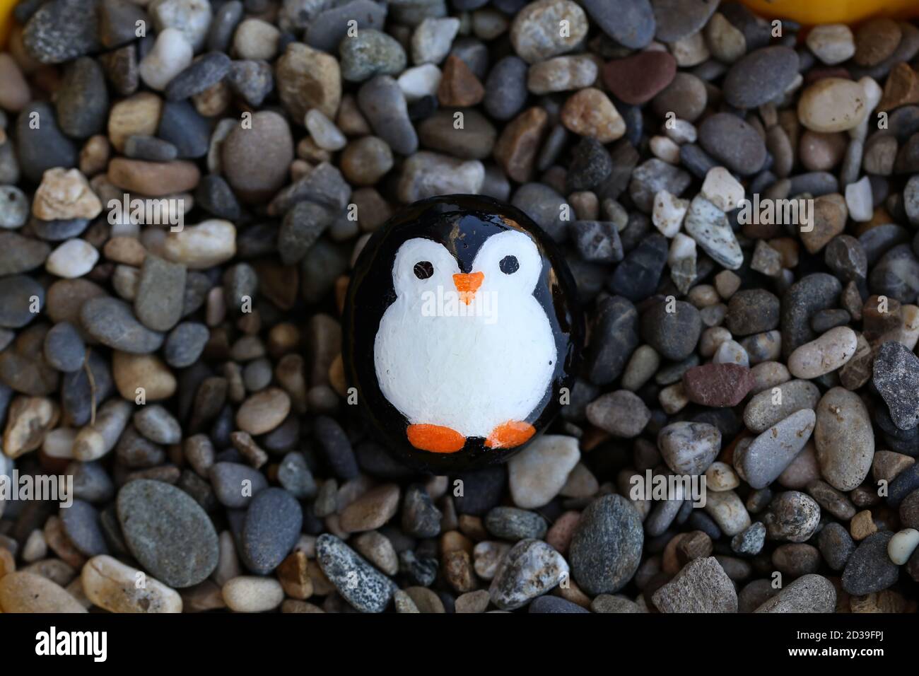 Top view of the painted penguin stone on the ground for the hikers ...
