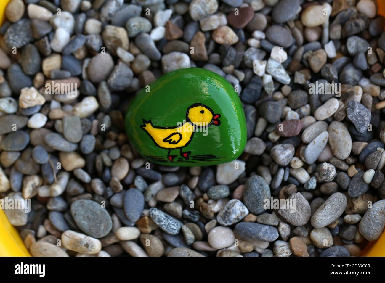Stone with a duck painted on it Stock Photo - Alamy