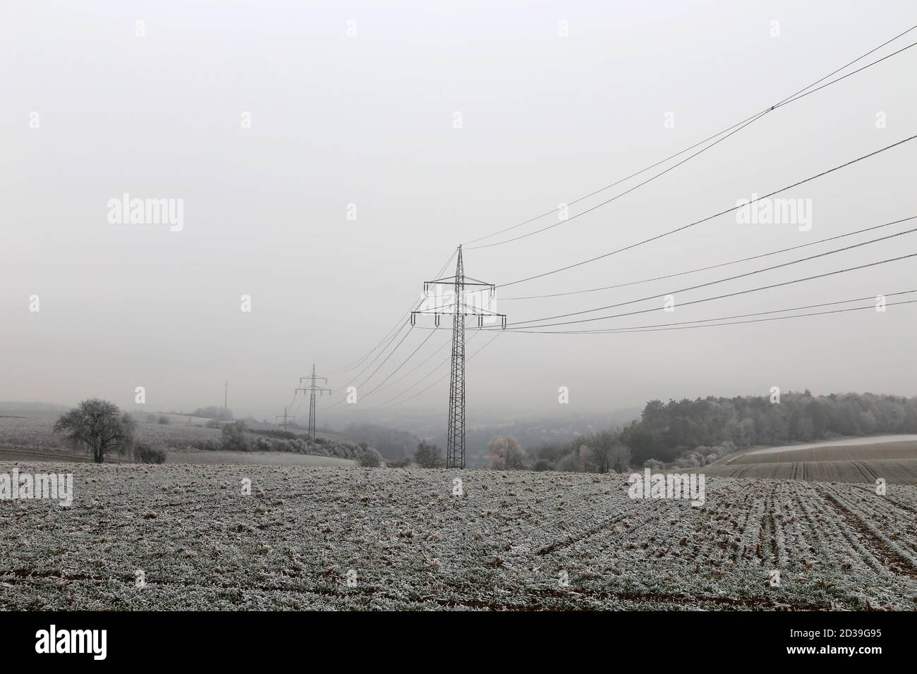 Giant transmission tower in the field covered in snow Stock Photo - Alamy