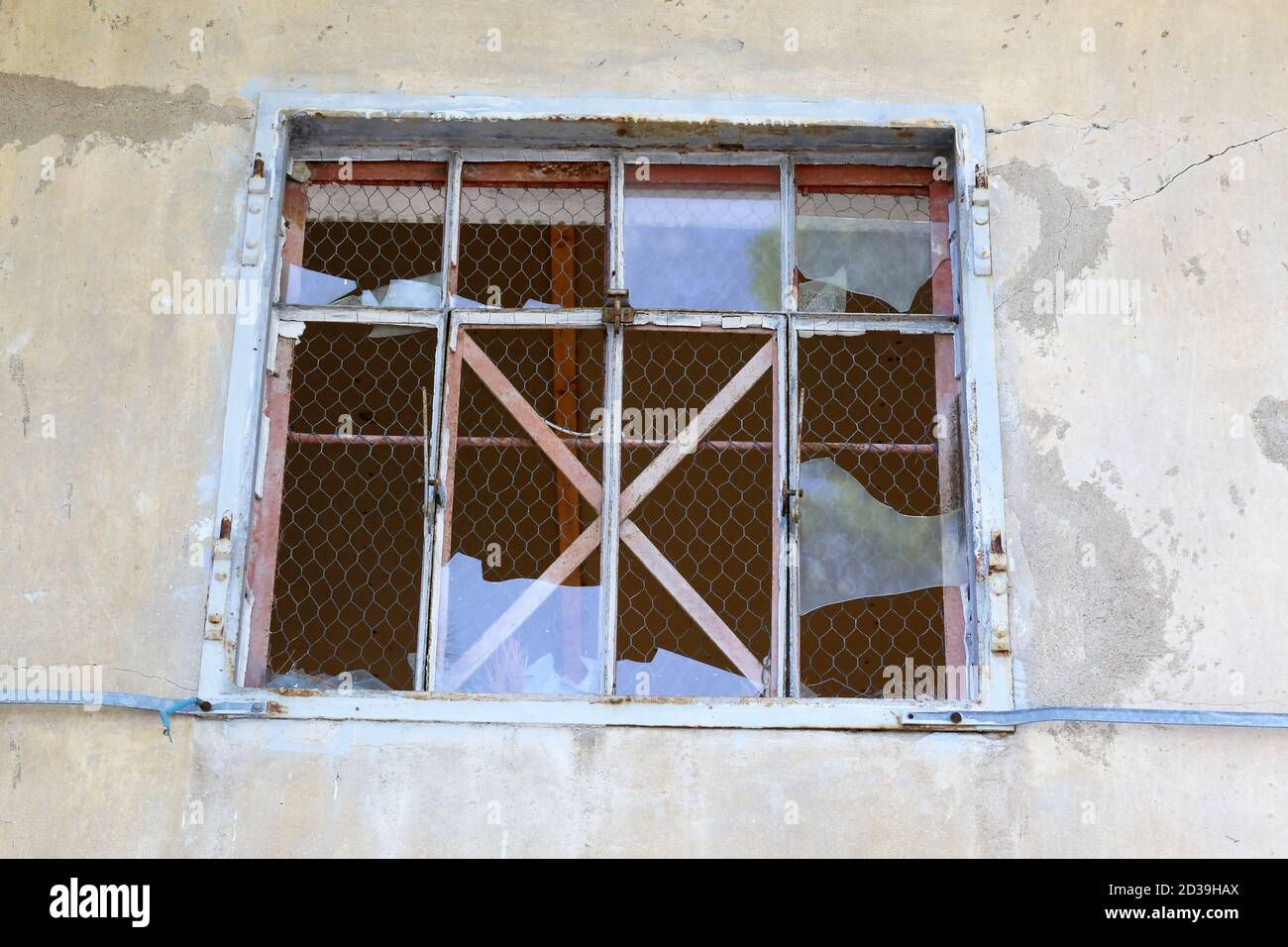 Window with mesh barns and broken window Stock Photo - Alamy