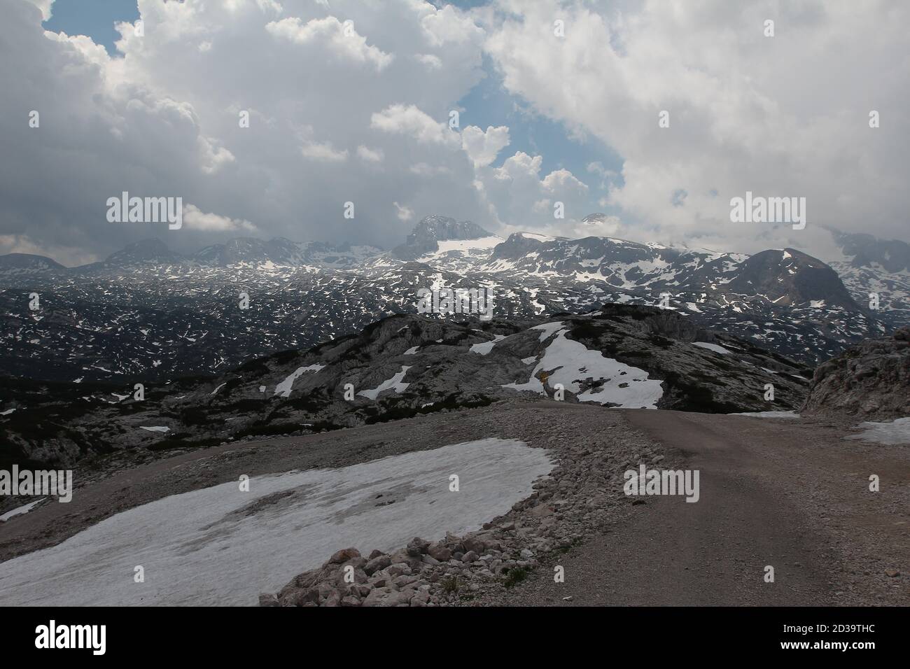 Beautiful high mountains covered in snow under the cloudy sky Stock ...