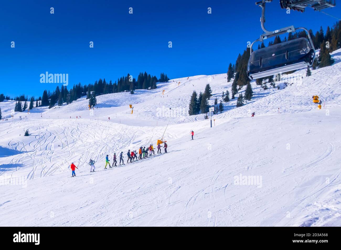 Saalbach, Austria panorama ski lift and skiers at ski slope of austrain ...