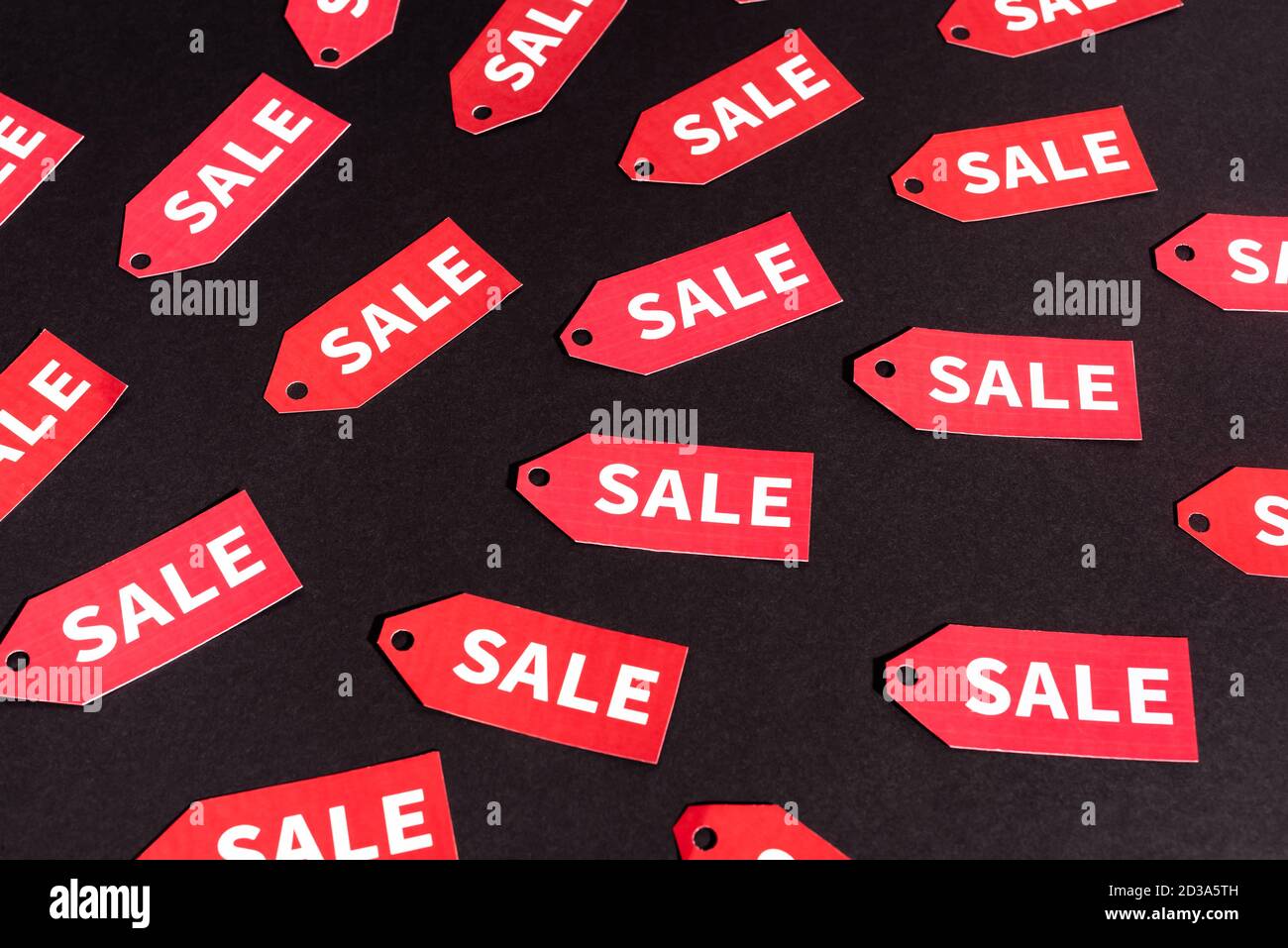 red labels with sale lettering on black background Stock Photo - Alamy