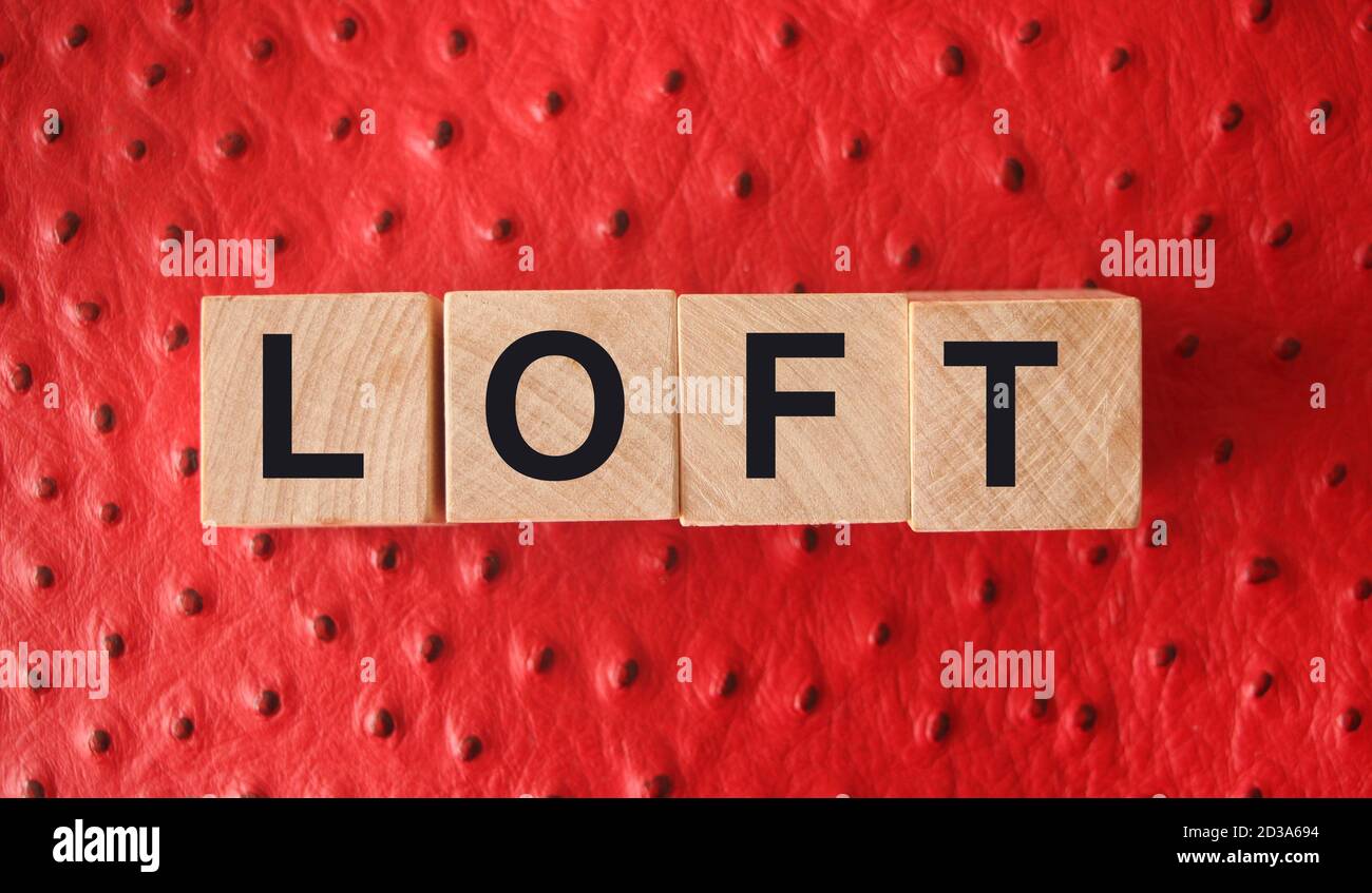 word loft letters on wooden cubes, on red leather background. Interior ...