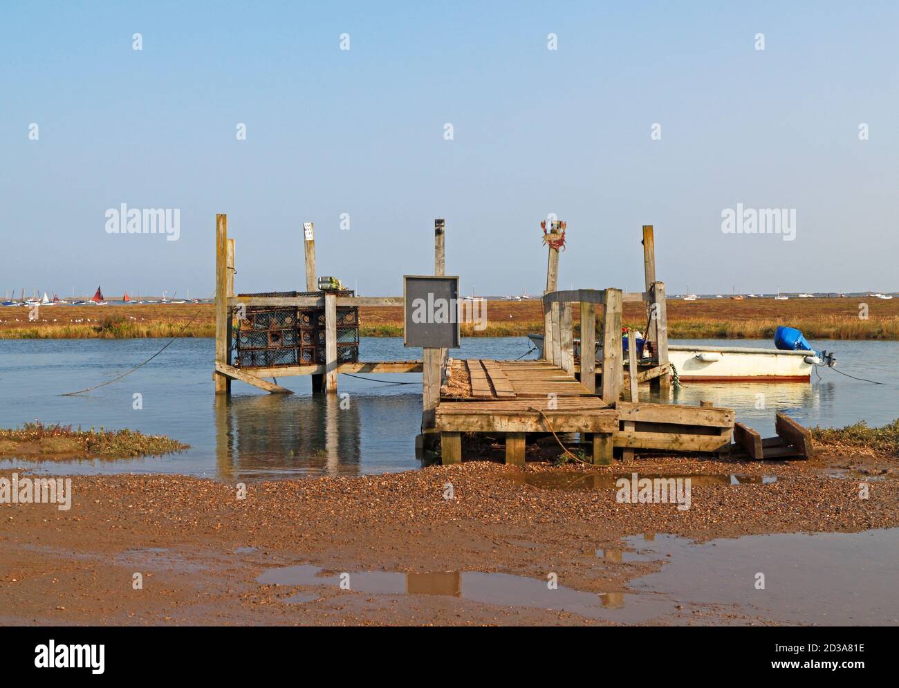 Mooring point with stacked crab pots and small fishing boat on the ...