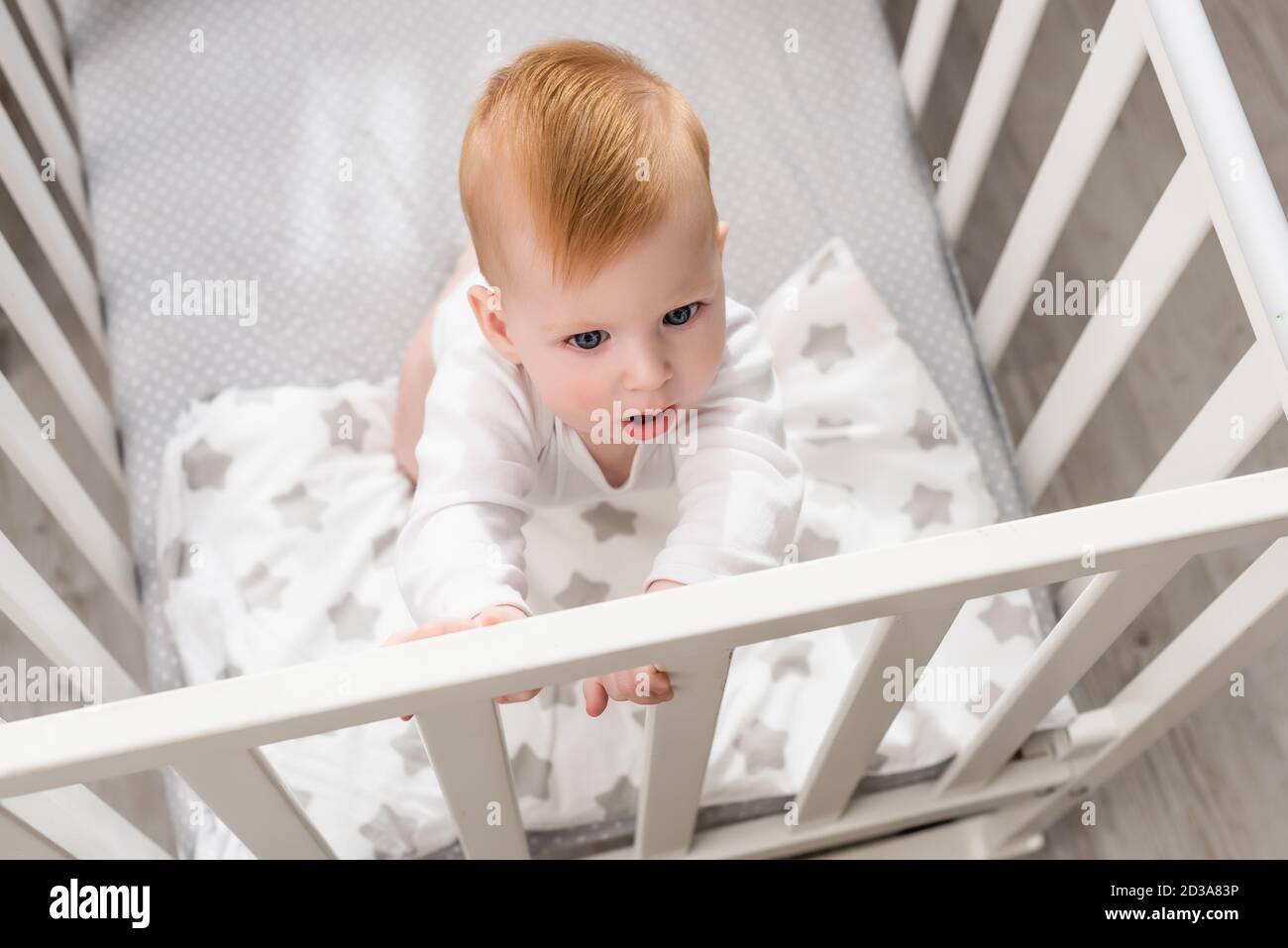 Happy baby standing in crib hi-res stock photography and images - Alamy