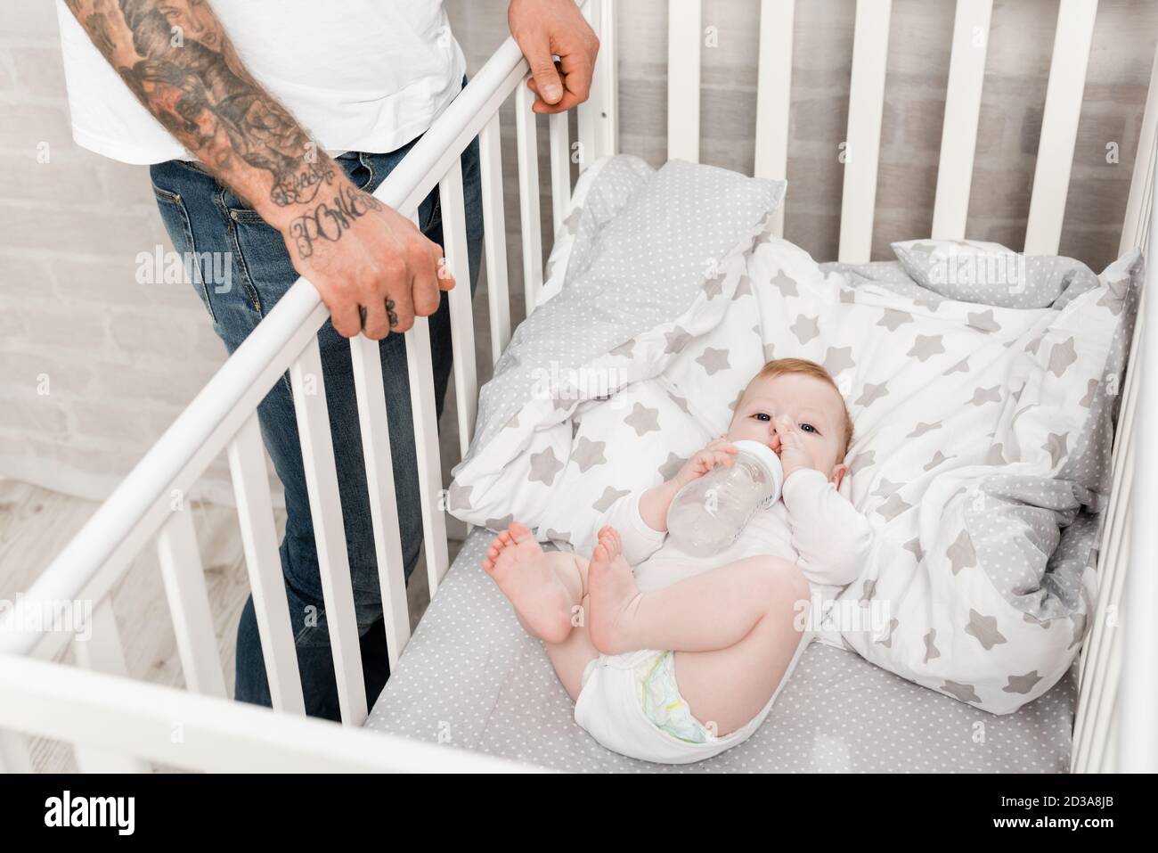 Father baby cot hi-res stock photography and images - Alamy
