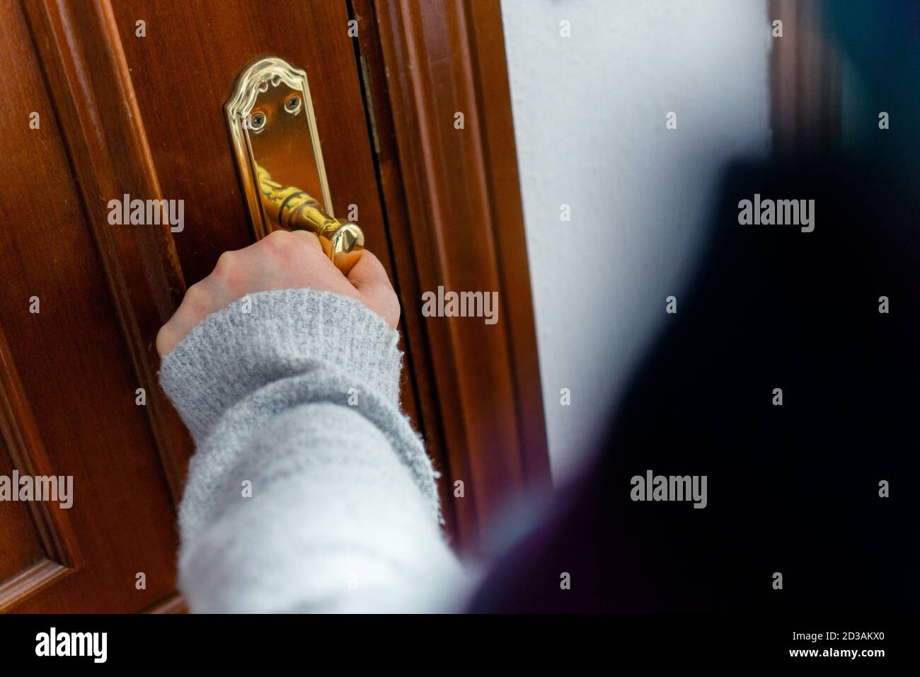 Woman opening a wooden door hi-res stock photography and images - Alamy