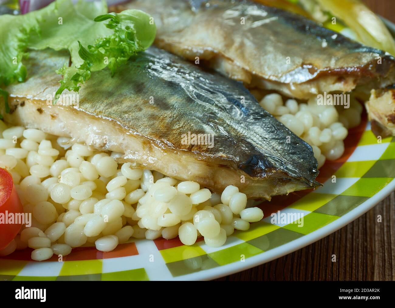 Israeli Fried mackerel fish with Ptitim close up Mediterranean cuisine ...