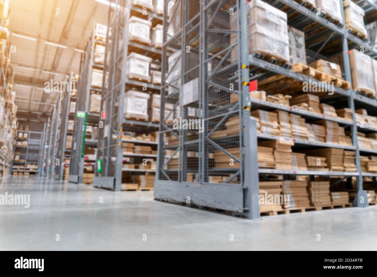 blurred background picture of Rows of shelves with goods boxes in ...