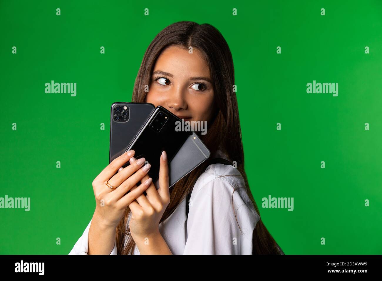 Teen schoolgirl with various smartphones. Content female teenager ...