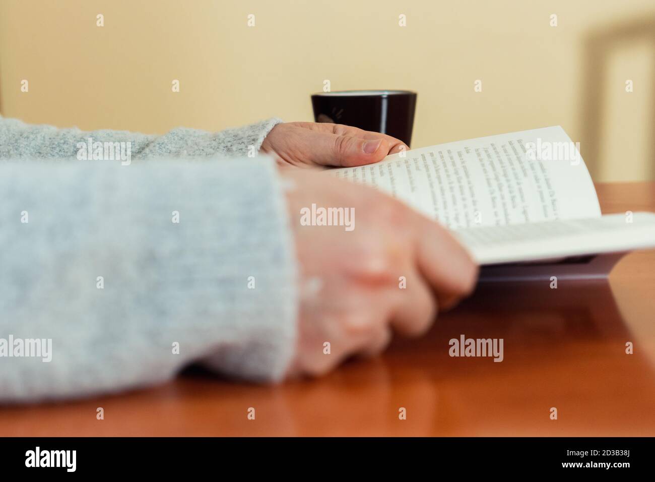 Shot of a woman's hand with an open book Stock Photo - Alamy