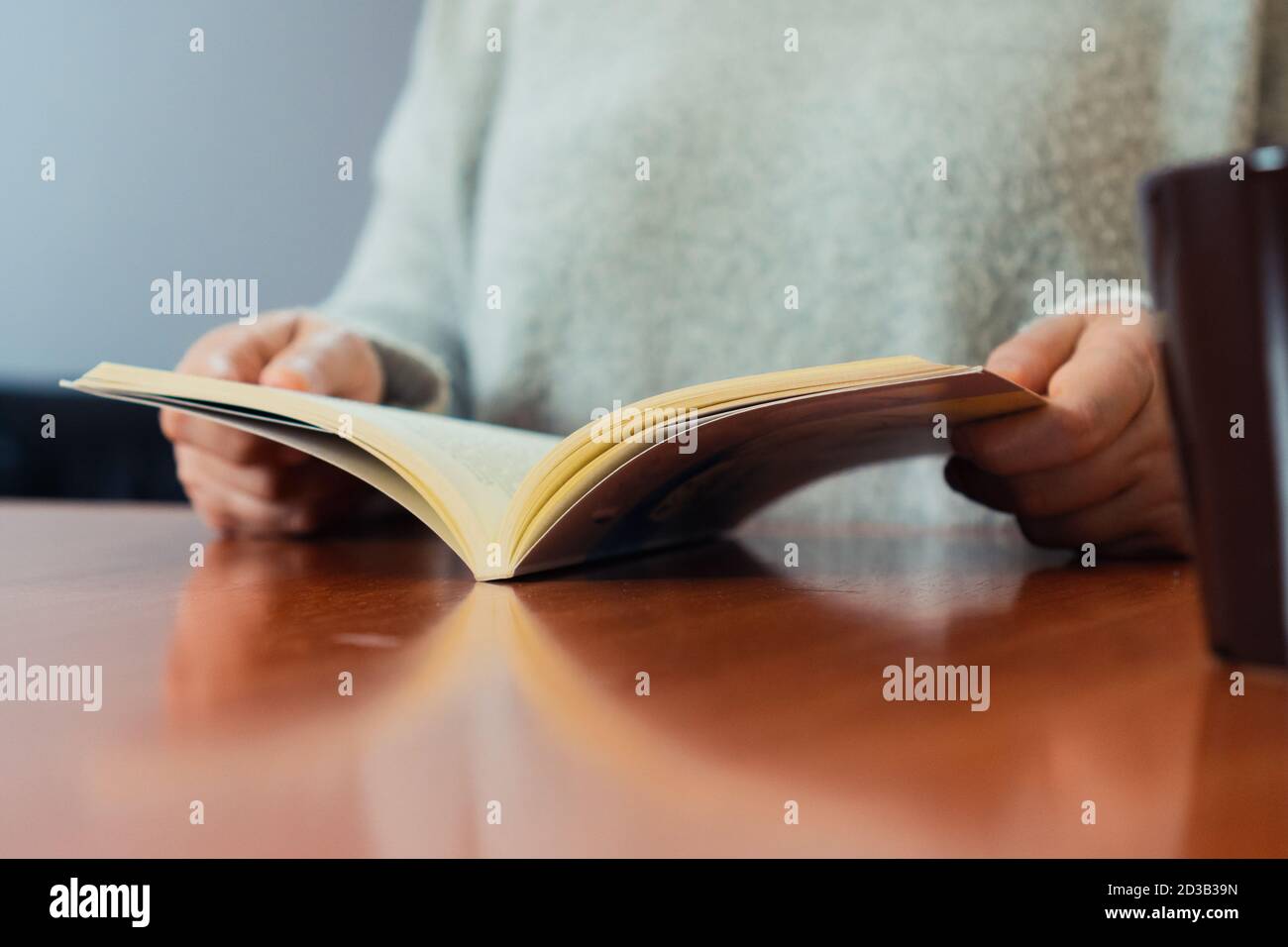 Shot of a woman's hand with an open book Stock Photo - Alamy