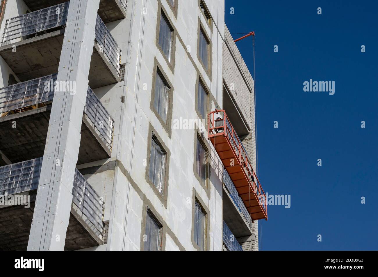 Thermal insulation of the walls of a new unfinished apartment building ...