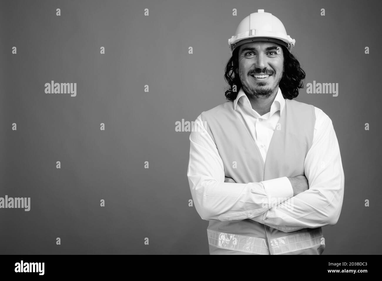 Handsome man construction worker with mustache against gray background ...