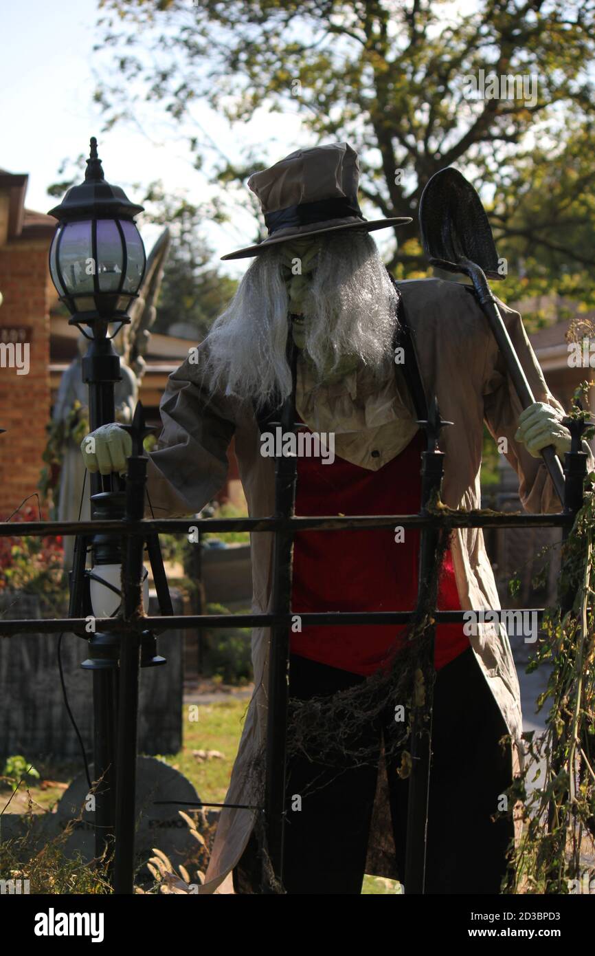 Halloween imagery of a nightmarish haunted graveyard and an old man ...