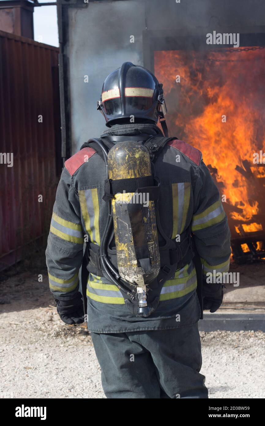 Firefighter putting out fire training station extinguisher backdraft ...