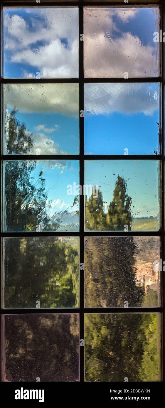 A window with multi-colored glass that overlooks a park Stock Photo - Alamy