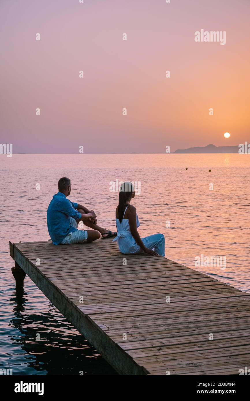 Crete Greece, young romantic couple in love is sitting and hugging on ...